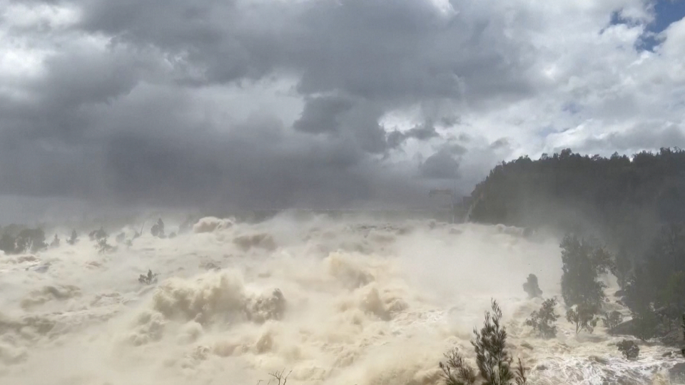 Raging Floodwaters Spill Out of Dam | WeatherBug