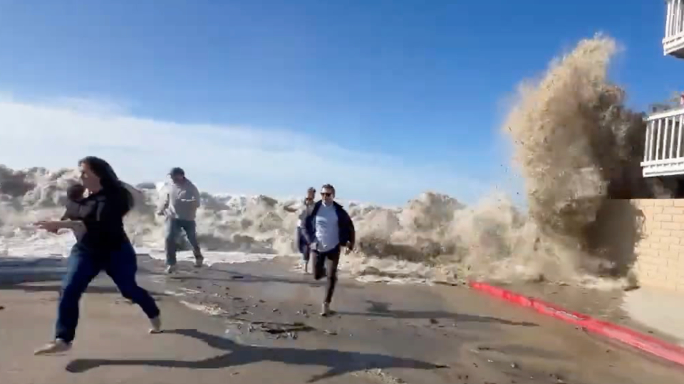 Massive Wave Knocks Over Beachgoers | WeatherBug