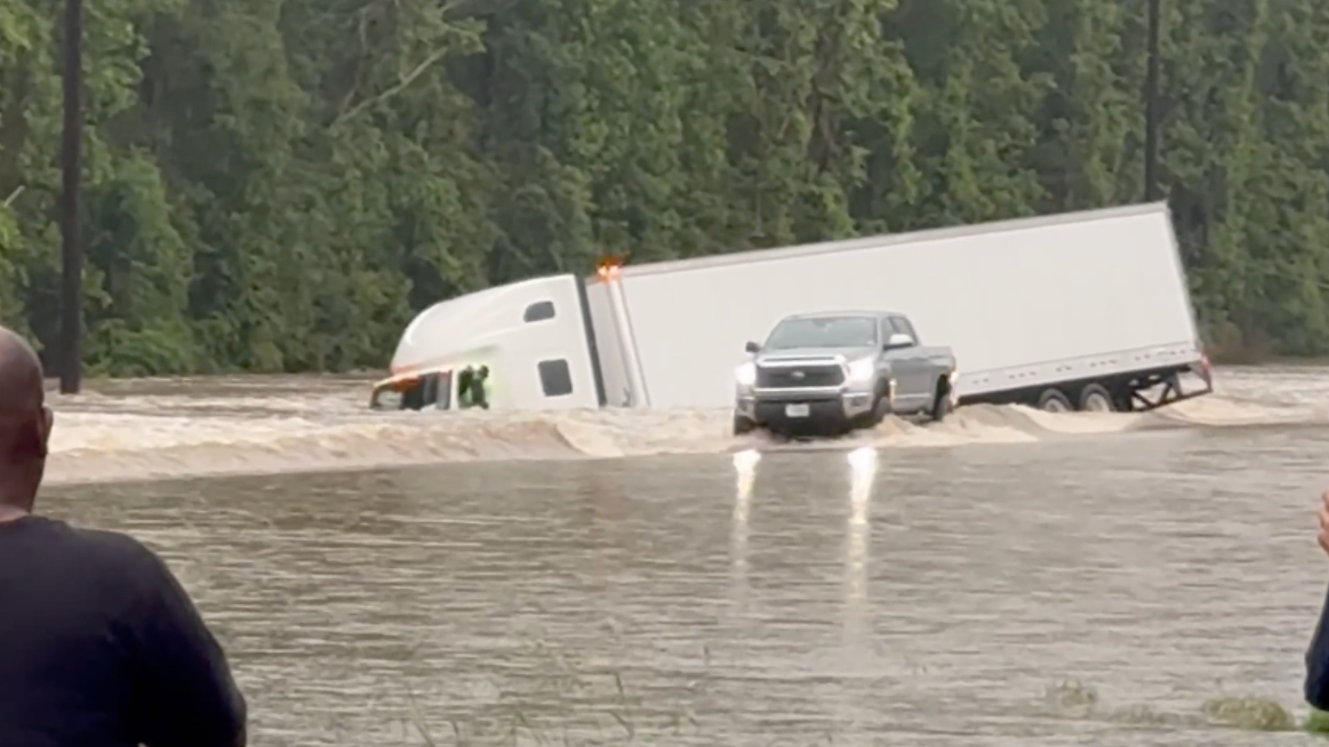 Truck Driver Scrambles Out as Vehicle Sinks | WeatherBug